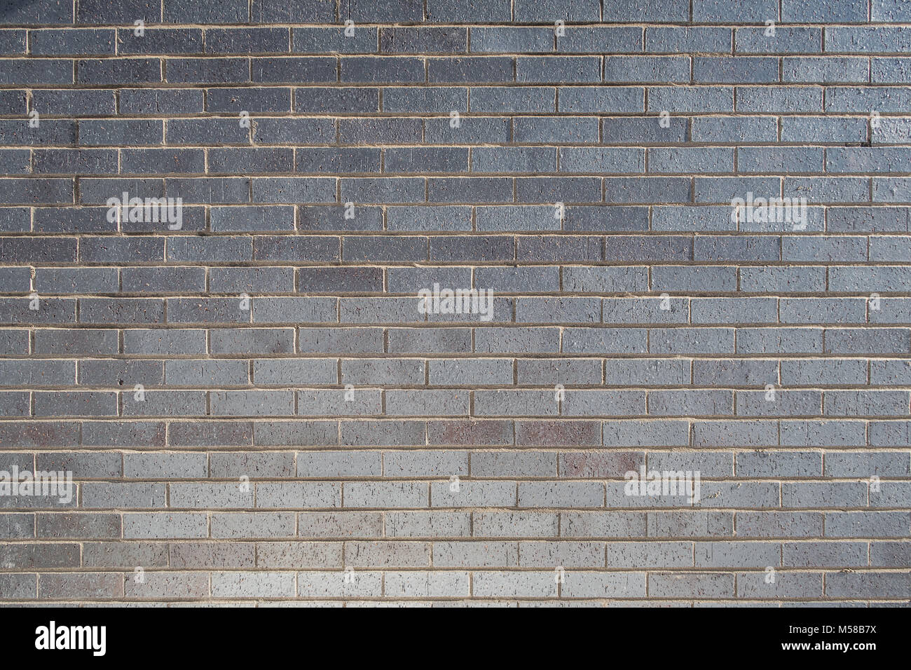 Texture of grey bricks with blue metallic reflects Stock Photo - Alamy