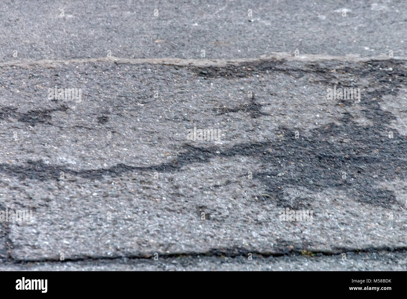Old asphalt serves as a footpath Stock Photo - Alamy