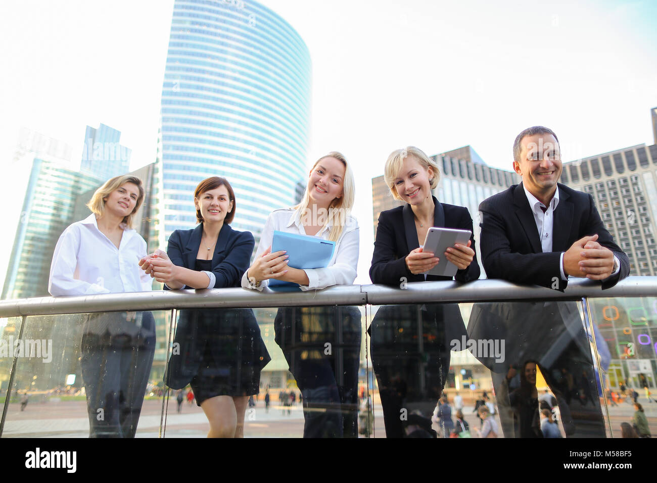 Close up faces financial team looking at camera keeping document Stock ...