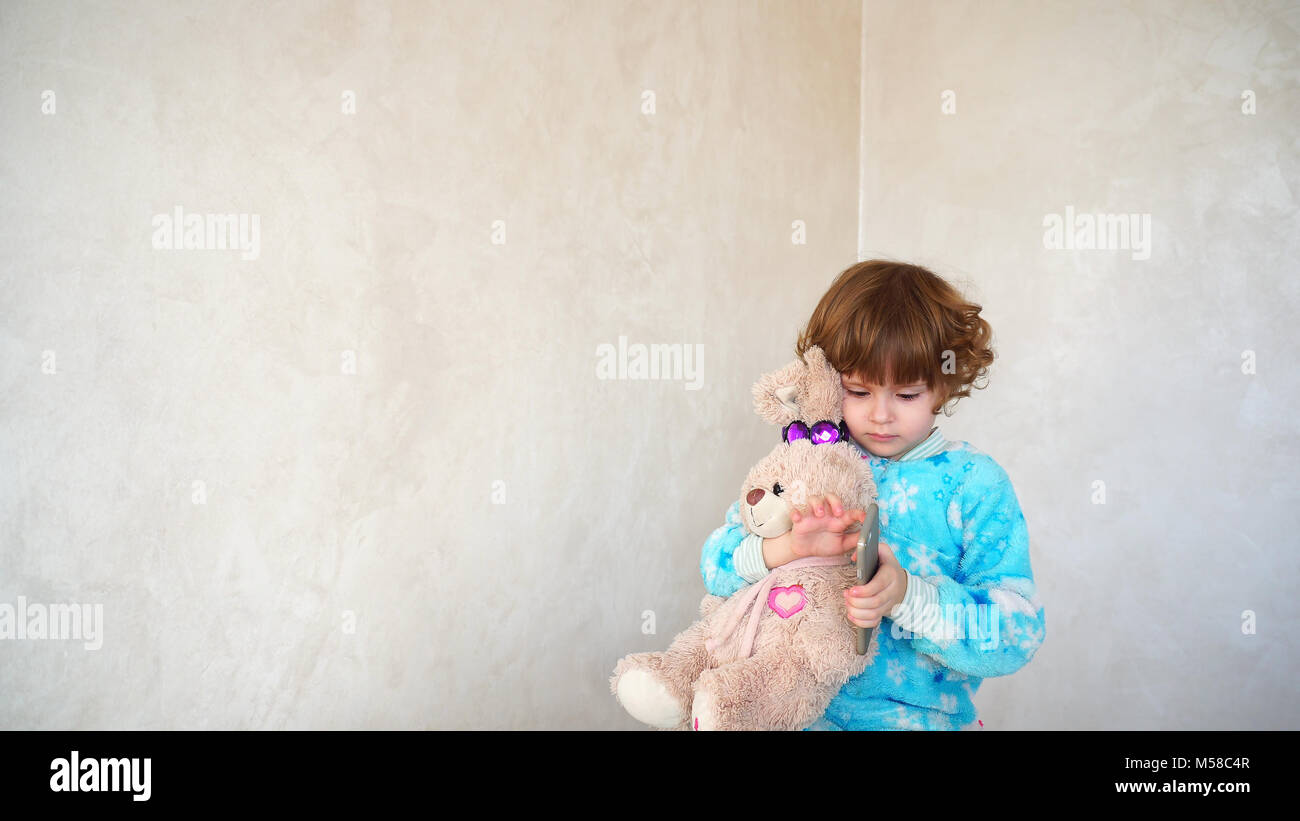 Small British kid dances with phone in hands Stock Photo - Alamy