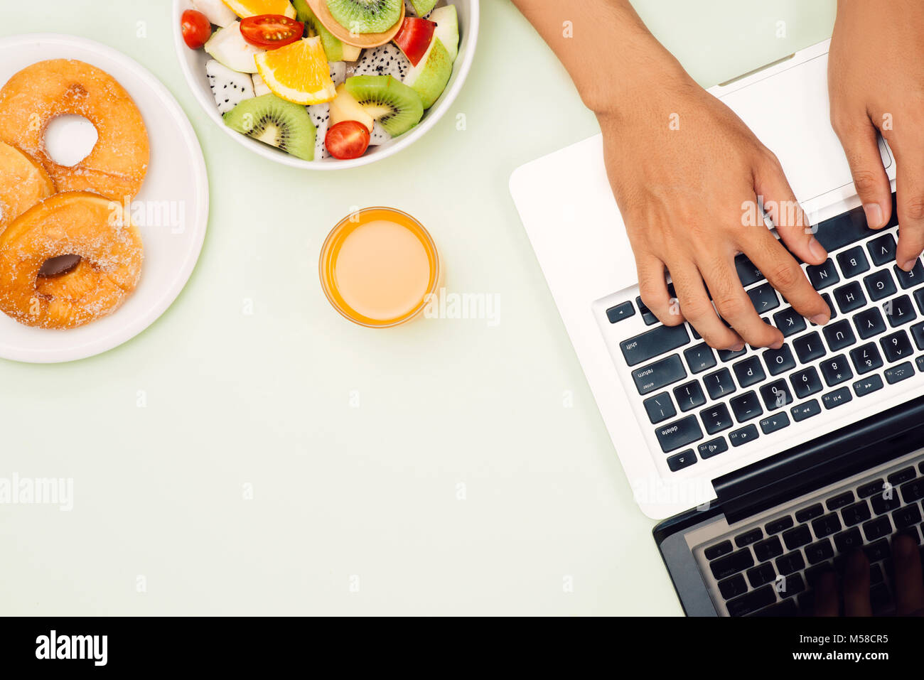 Healthy business lunch in office, fruit salad bowl near laptop on white ...