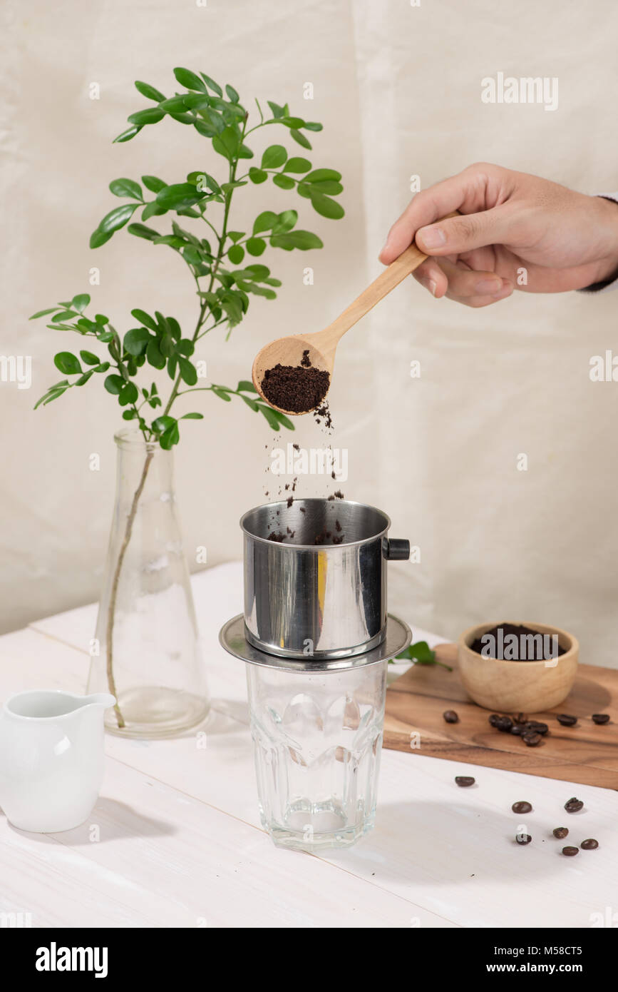 Coffee dripping in vietnamese style on wooden table Stock Photo - Alamy