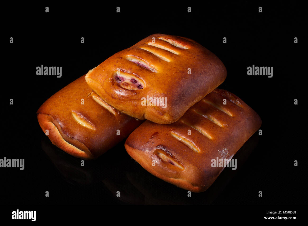 Bun with fruit filling on a dark background Stock Photo - Alamy