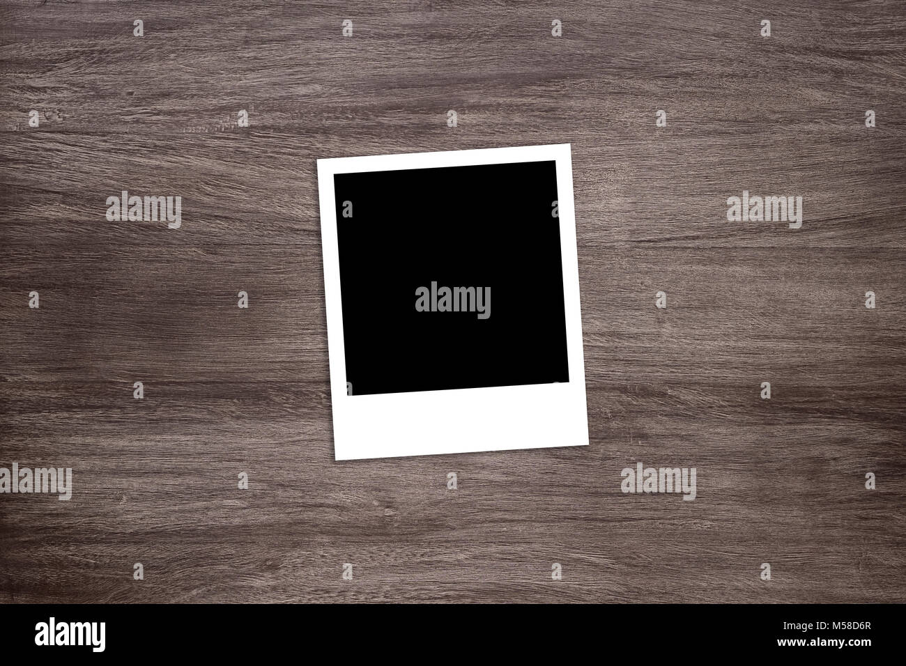 blackened instant photo print template on wooden background Stock Photo ...