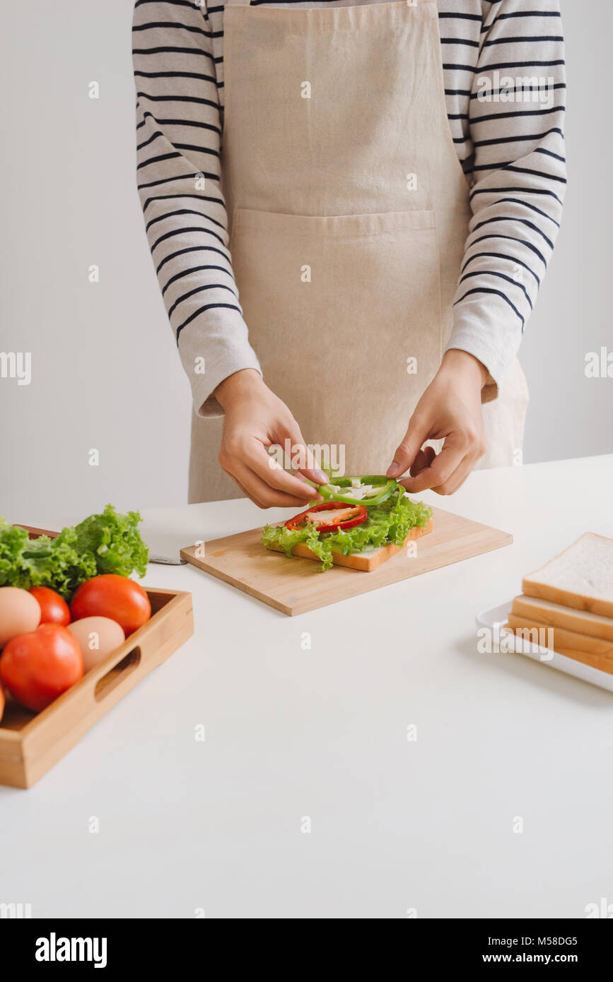 Hands of man prepare sandwich at home Stock Photo - Alamy