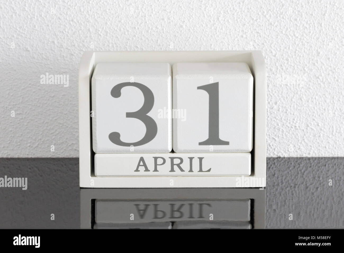 White block calendar present date 31 and month April on white wall ...