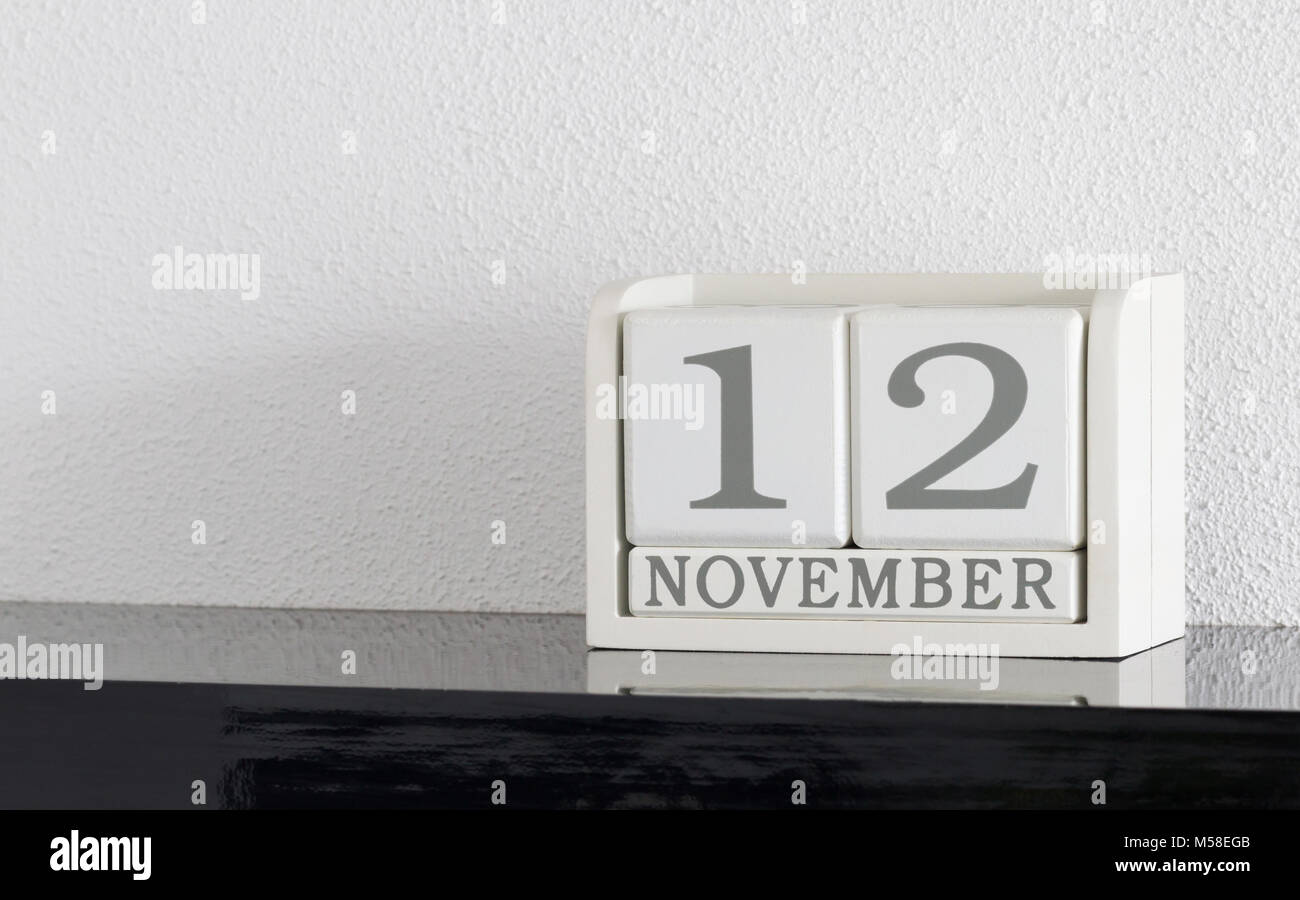 White block calendar present date 12 and month November on white wall ...
