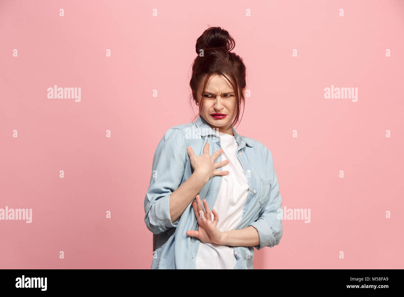 Young woman with disgusted expression repulsing something, isolated on ...