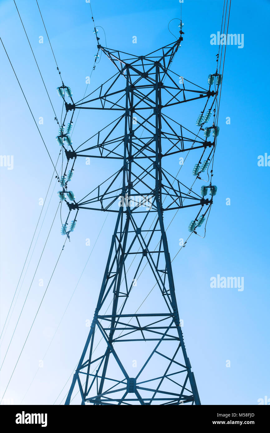 High voltage power line tower on a blue sky background Stock Photo - Alamy