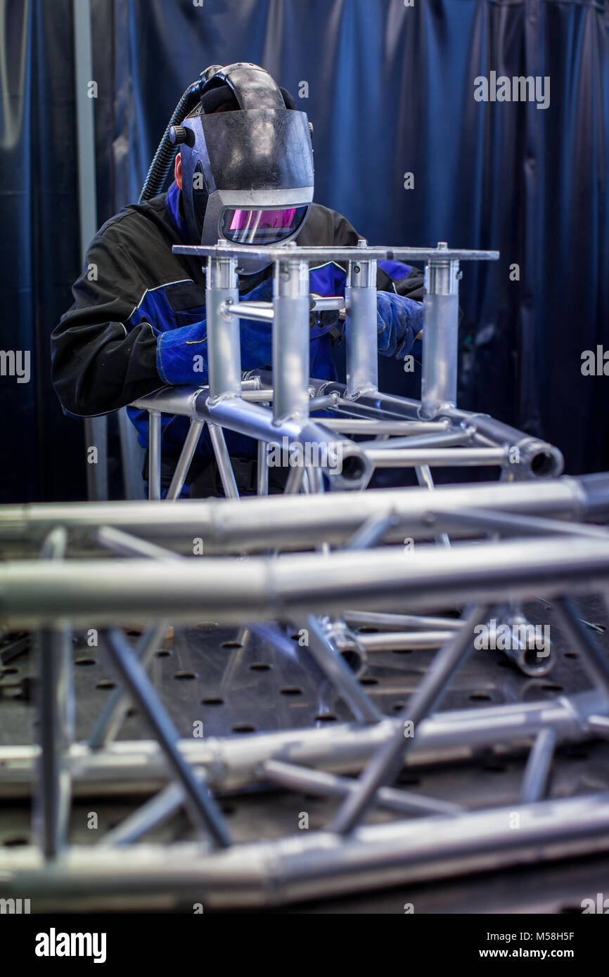 Industrial workers welding metal with many sharp sparks, Welder working ...