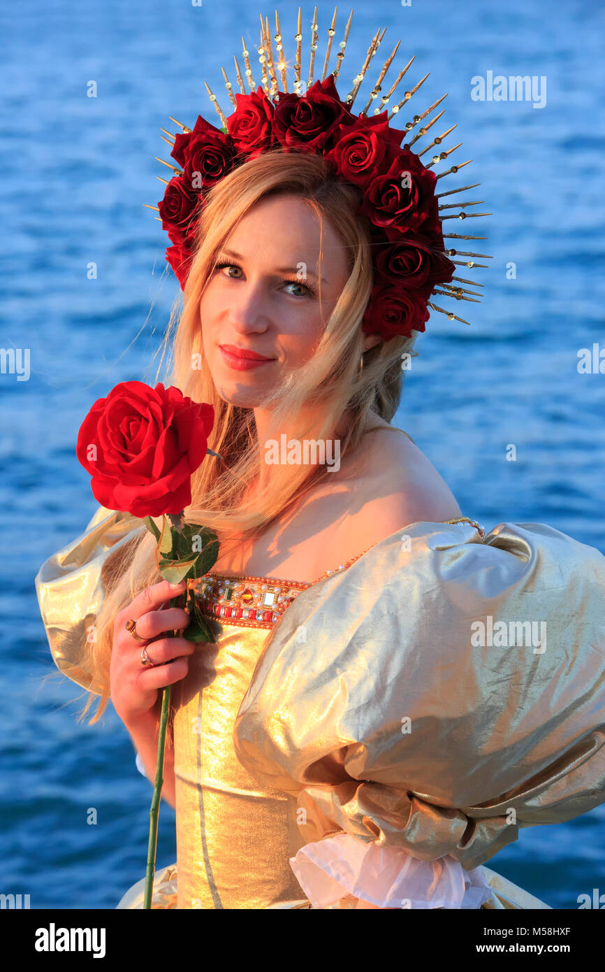 A beautiful damsel with a tiara made of red roses during the Carnival ...