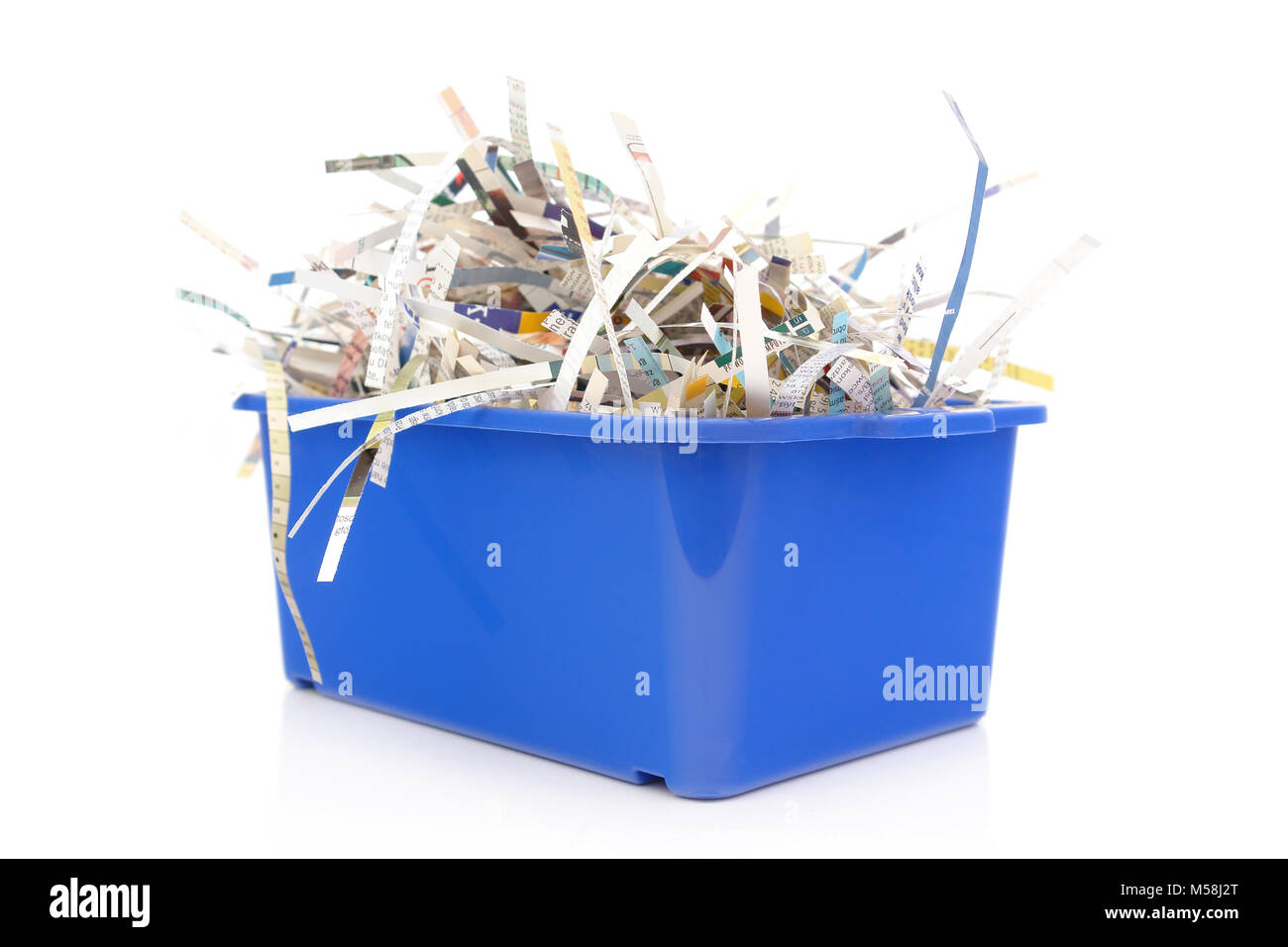 Blue plastic container full of old newspaper cuttings over white ...