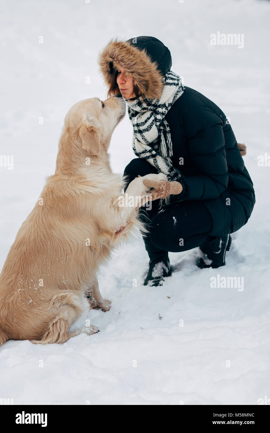 Picture of labrador giving paw to girl in black jacket on winter day ...