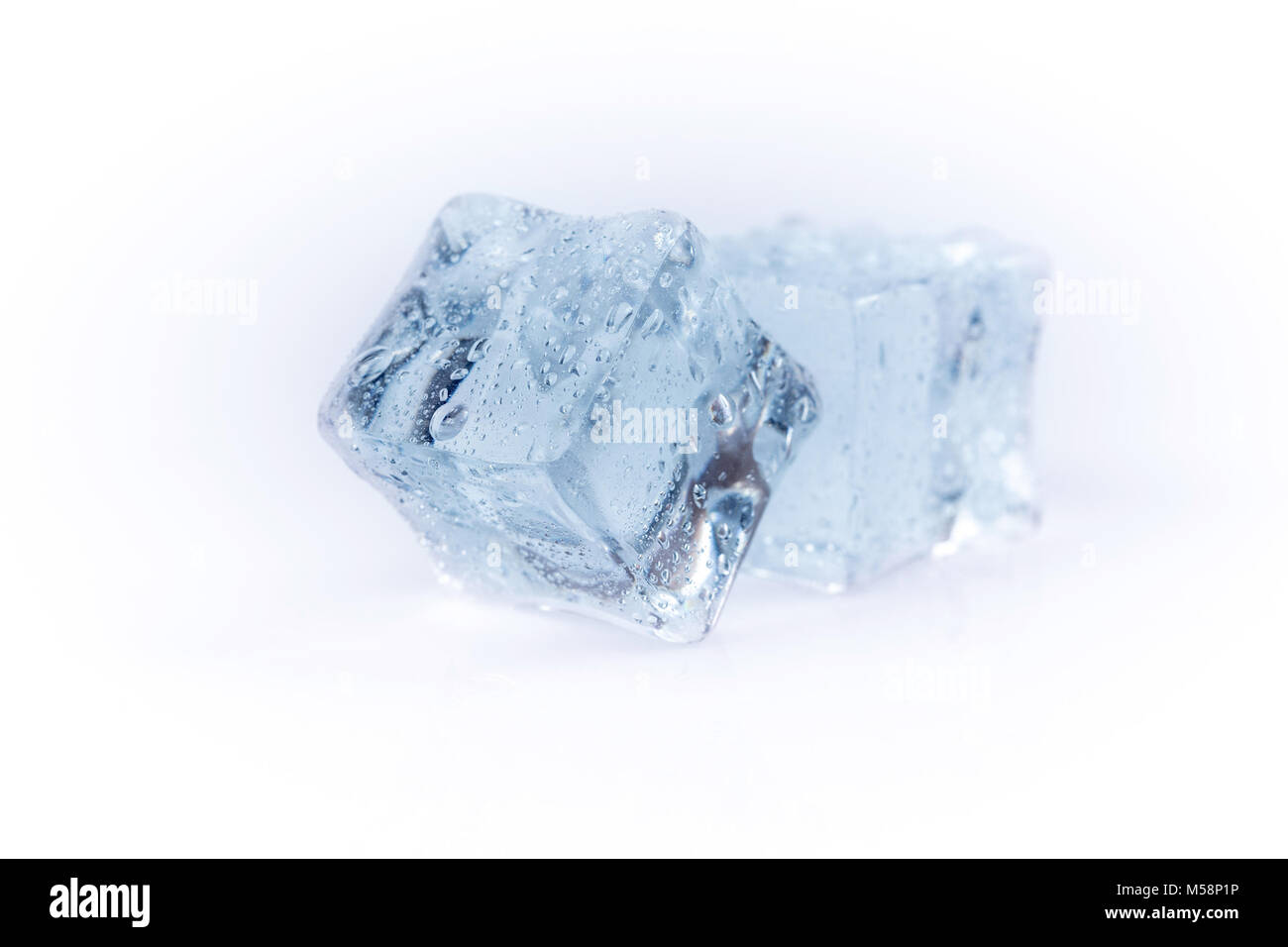 Two ice cubes on white reflection background Stock Photo - Alamy