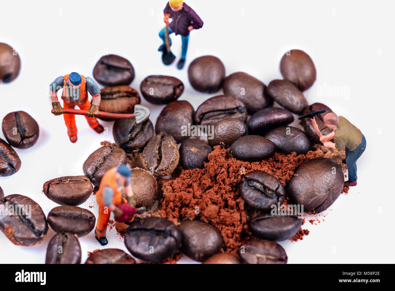 Miniature figures working on coffee macro photography on white ...