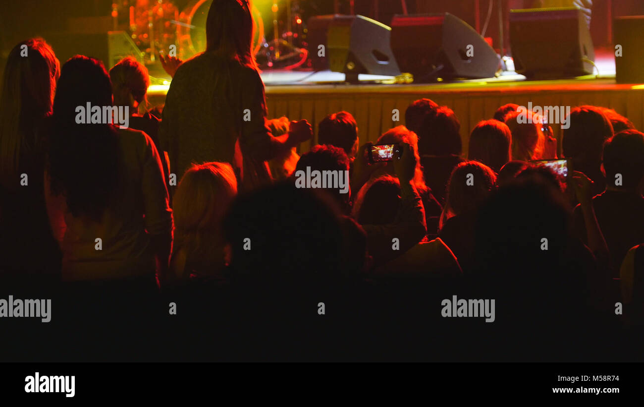 Spectators at a rock concert - crowd blurred Stock Photo - Alamy