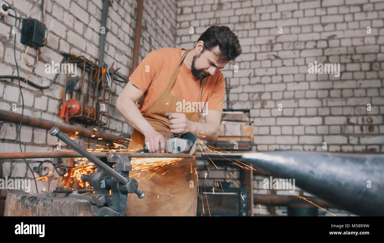 Blacksmith forging an knife with circular saw Stock Photo - Alamy