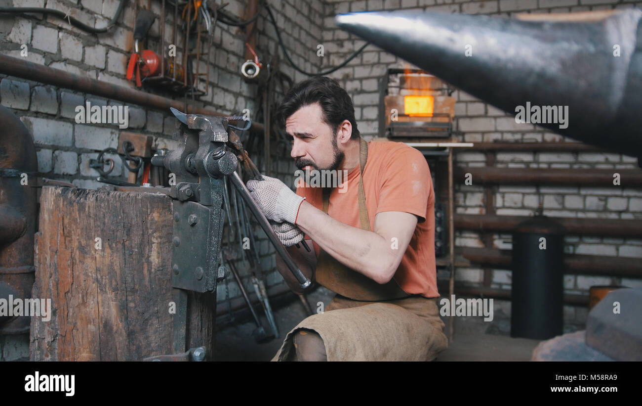 Blacksmith working with hot metal at the forge Stock Photo - Alamy