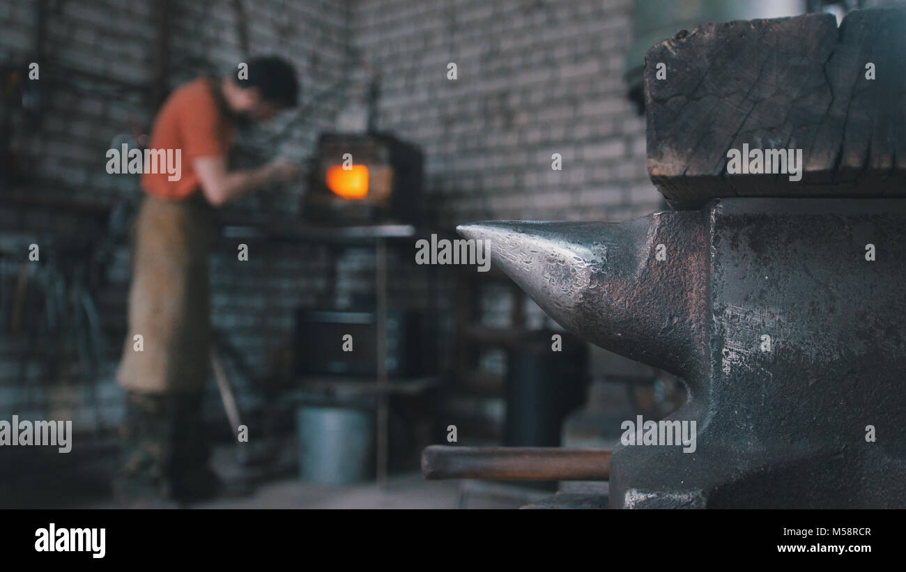The blacksmith in forge near furnace Stock Photo - Alamy