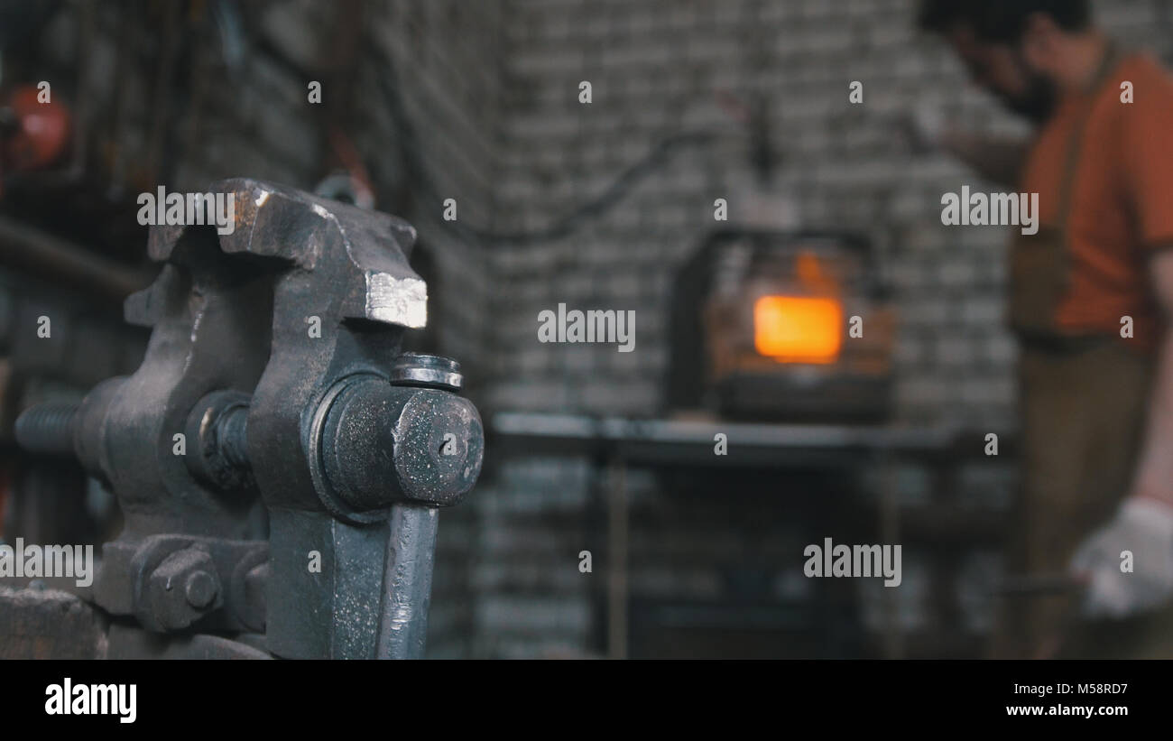 The blacksmith in forge near furnace Stock Photo - Alamy