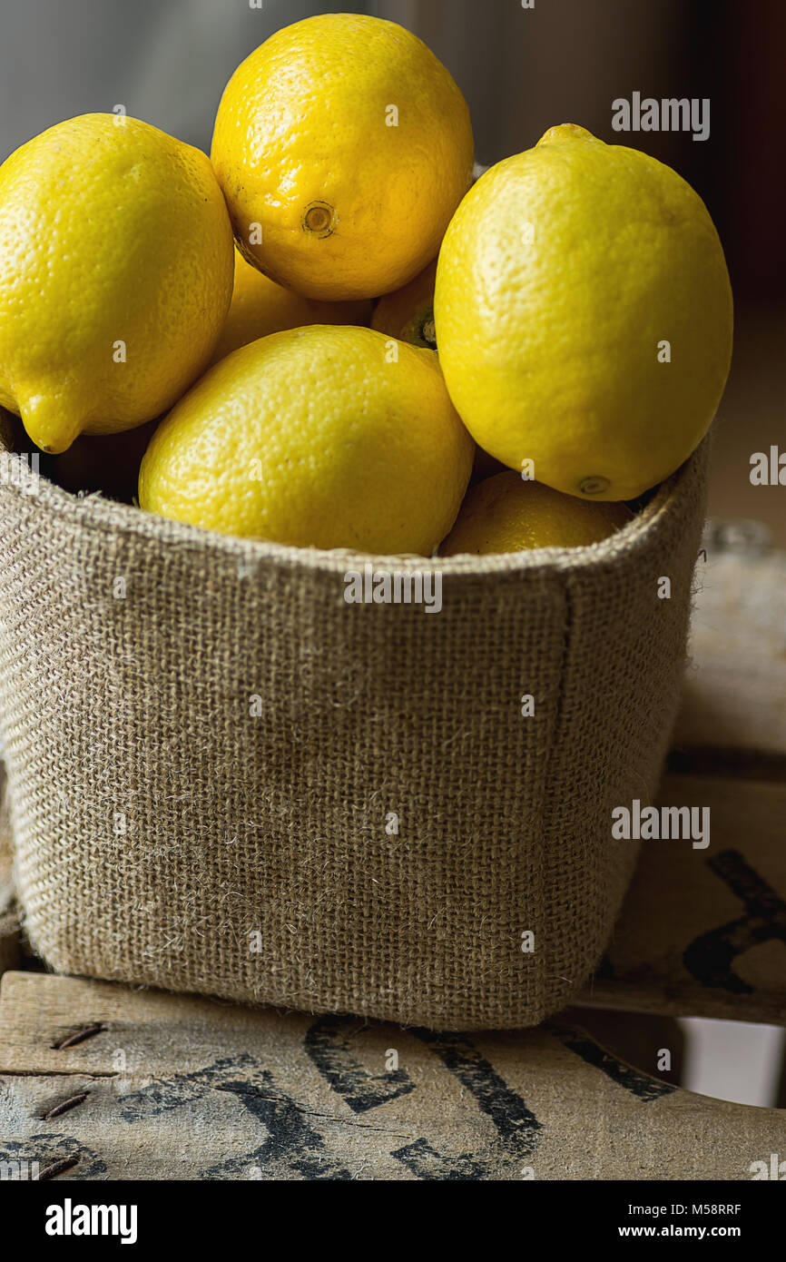 Heap of Ripe Organic Lemons in Jute Sack Standing on Wood Garden Box ...