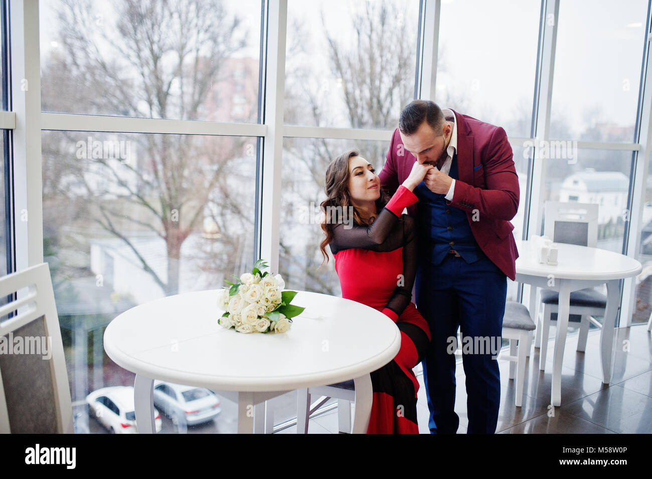 Couple in red love each other at restaurant indoor Stock Photo - Alamy