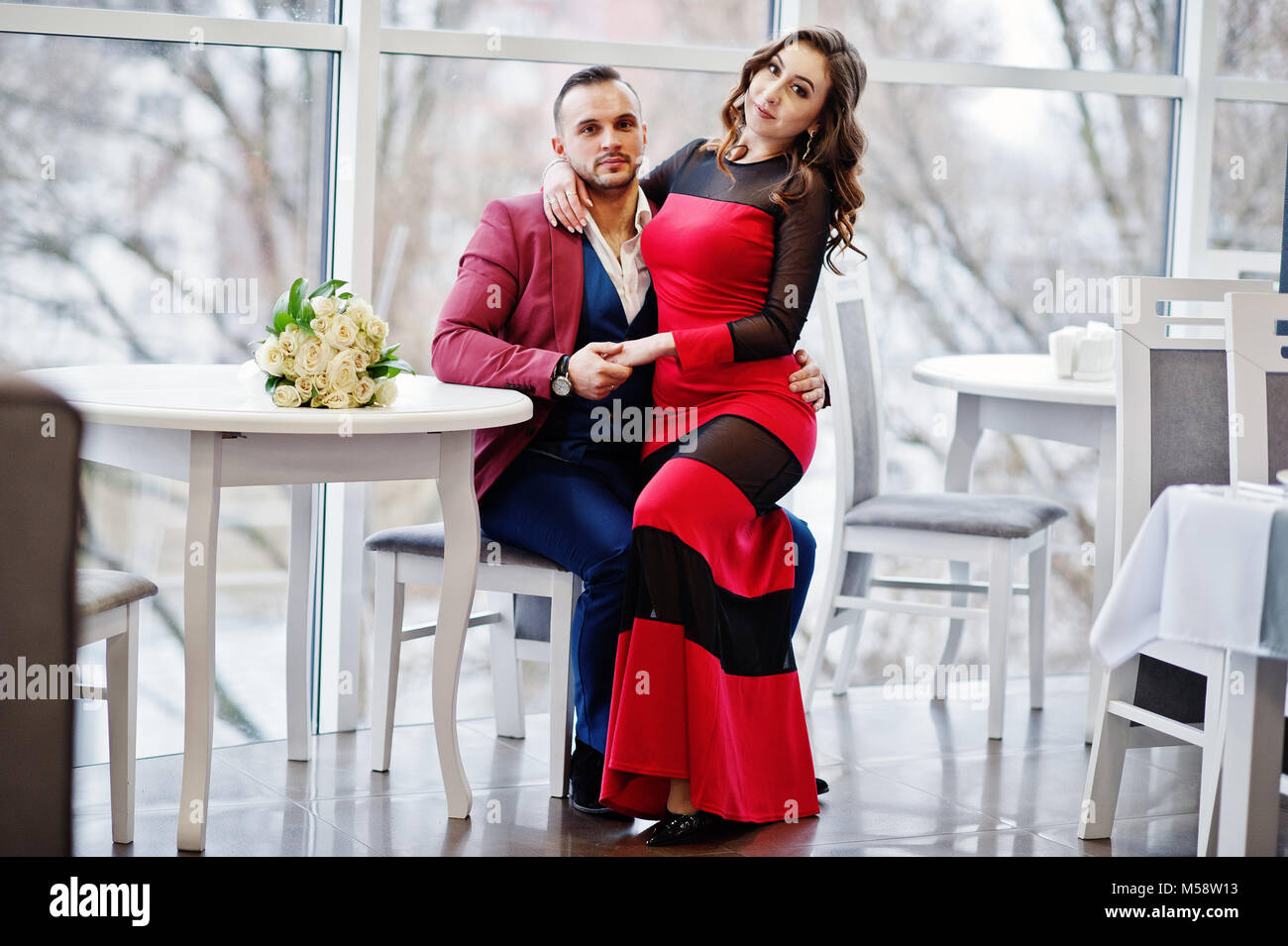 Couple in red love each other at restaurant indoor Stock Photo - Alamy