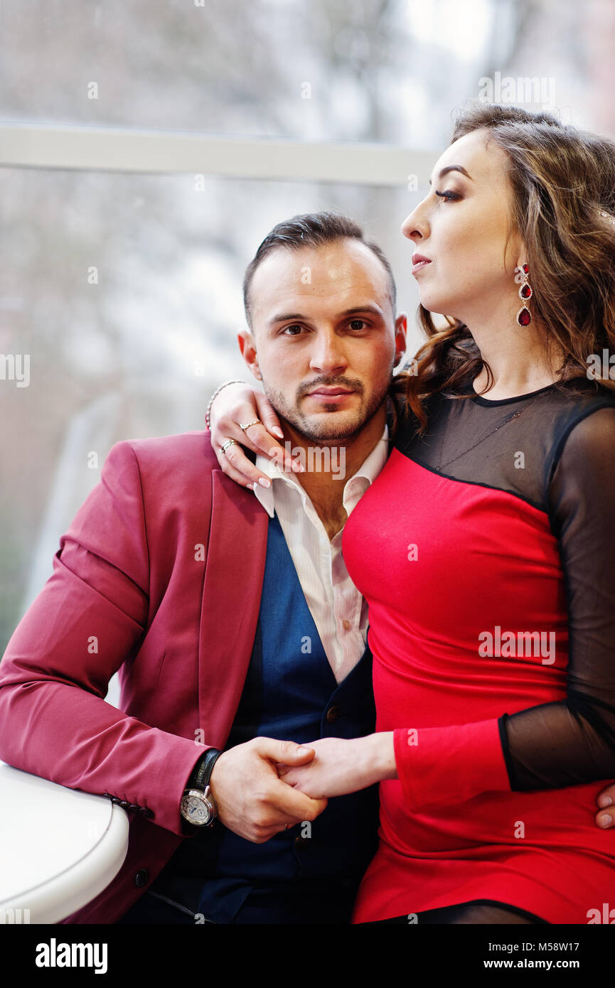 Couple in red love each other at restaurant indoor Stock Photo - Alamy