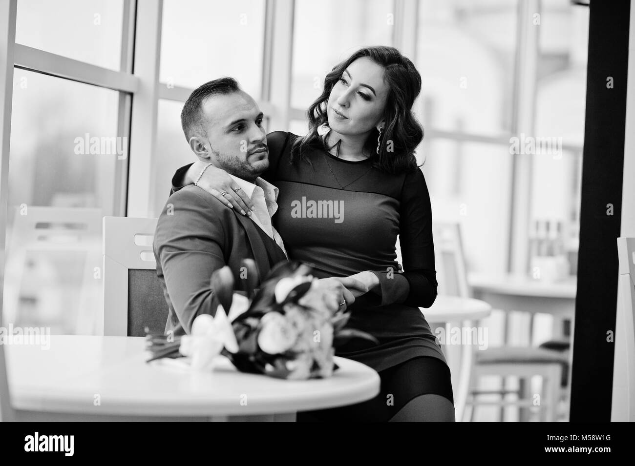 Couple in red love each other at restaurant indoor Stock Photo - Alamy
