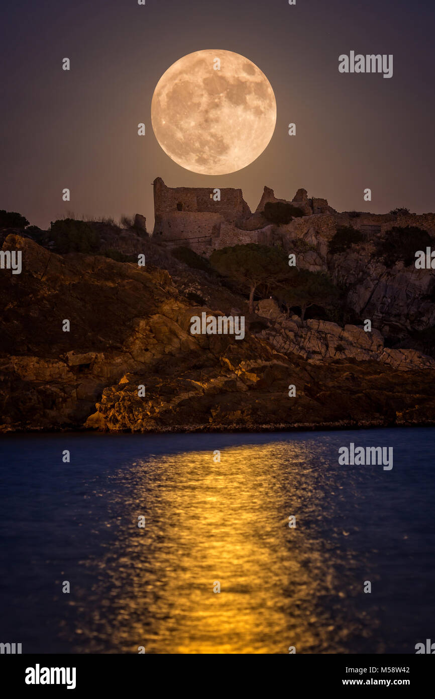 Full moon over the old castle in Costa Brava in a holiday village Fosca ...