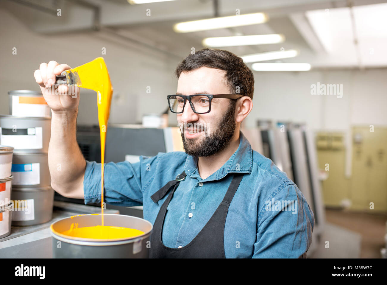Typographer with paint at the manufacturing Stock Photo - Alamy