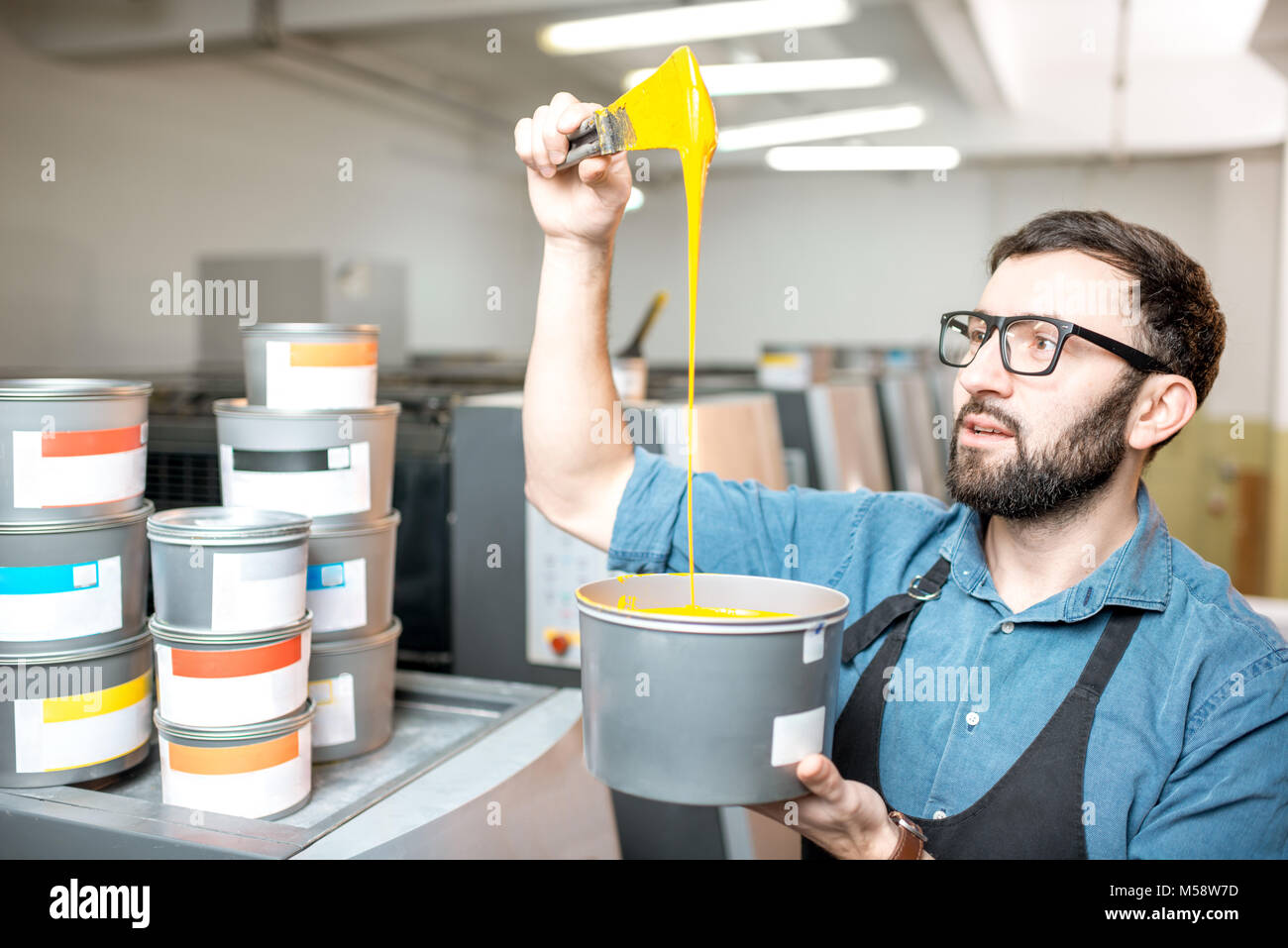 Typographer with paint at the manufacturing Stock Photo - Alamy