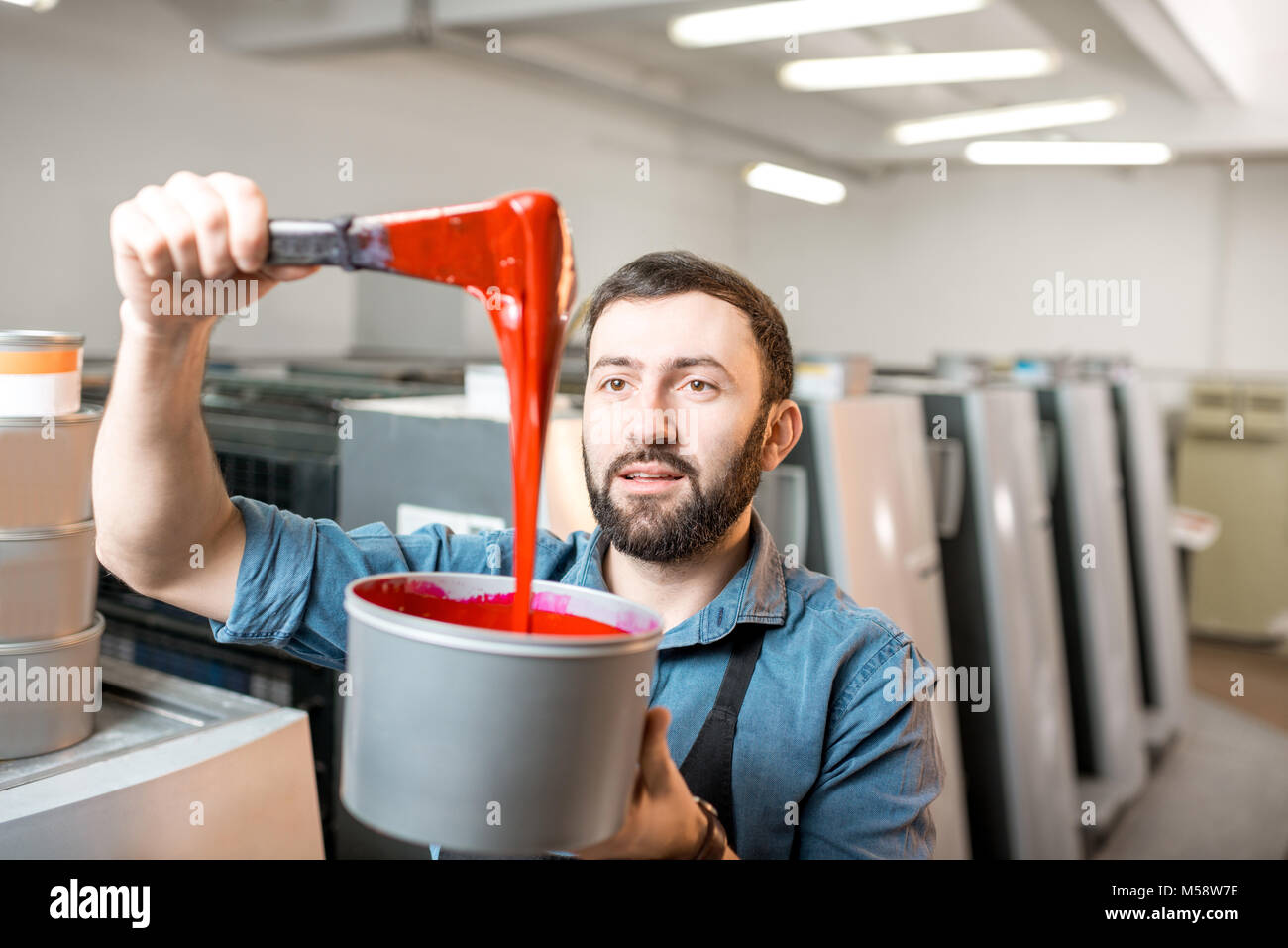 Typographer with paint at the manufacturing Stock Photo - Alamy