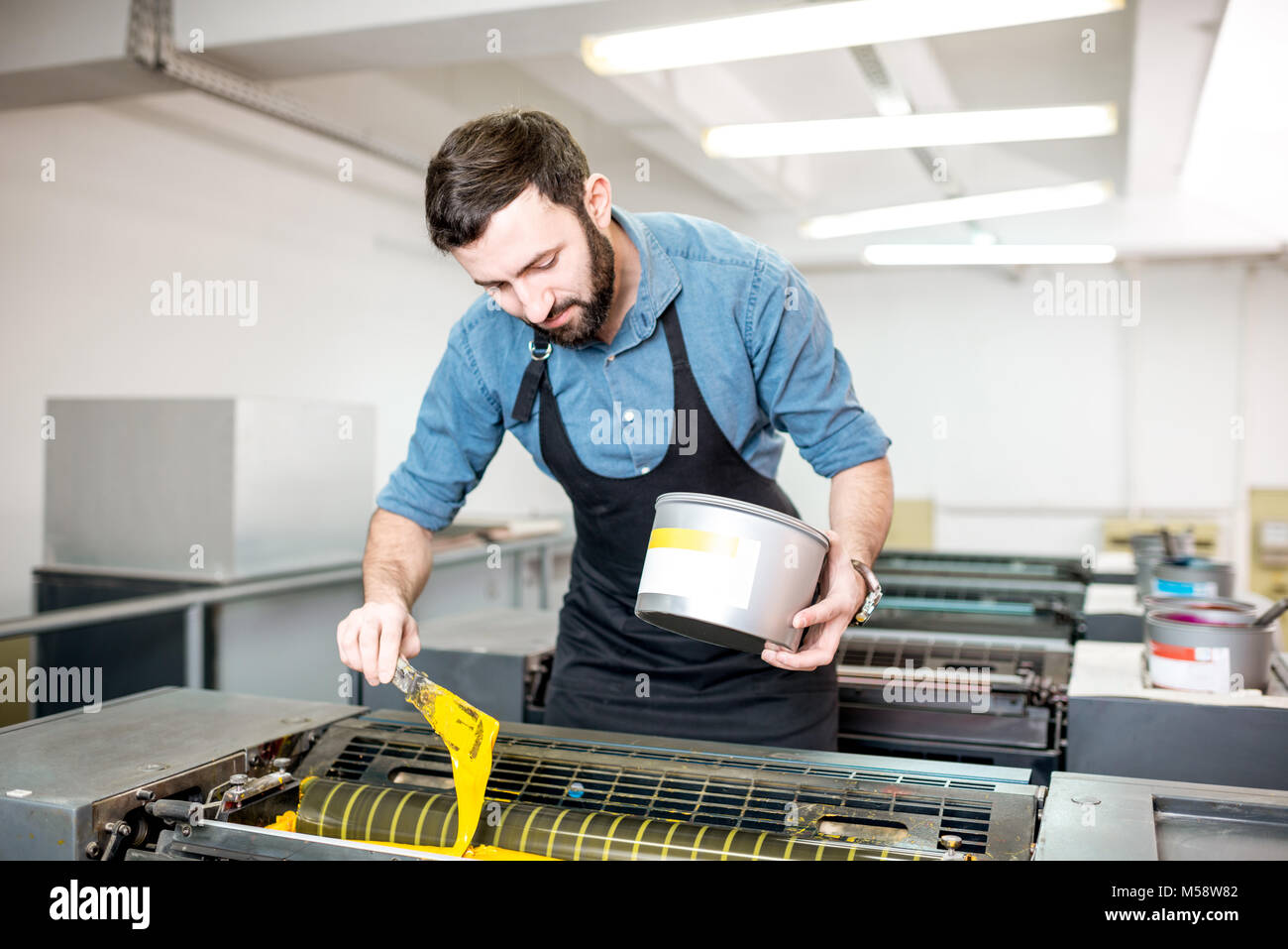 Typographer with paint at the manufacturing Stock Photo - Alamy