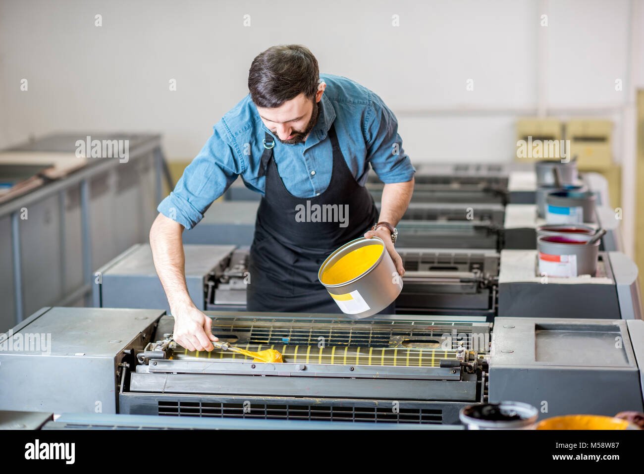 Typographer with paint at the manufacturing Stock Photo - Alamy