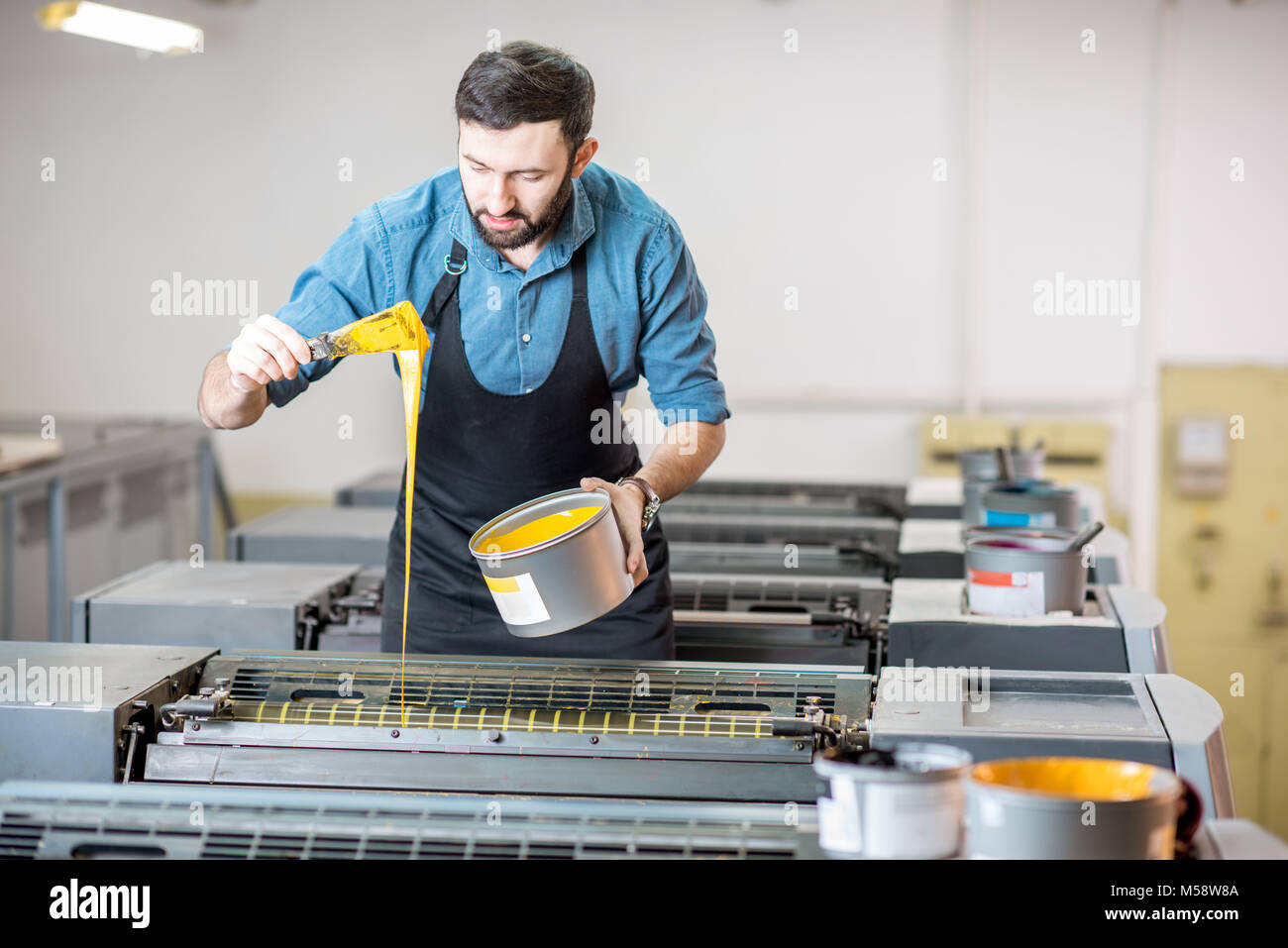 Typographer with paint at the manufacturing Stock Photo - Alamy
