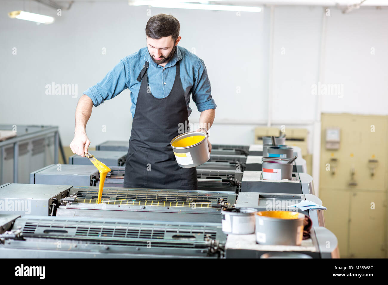 Typographer with paint at the manufacturing Stock Photo - Alamy