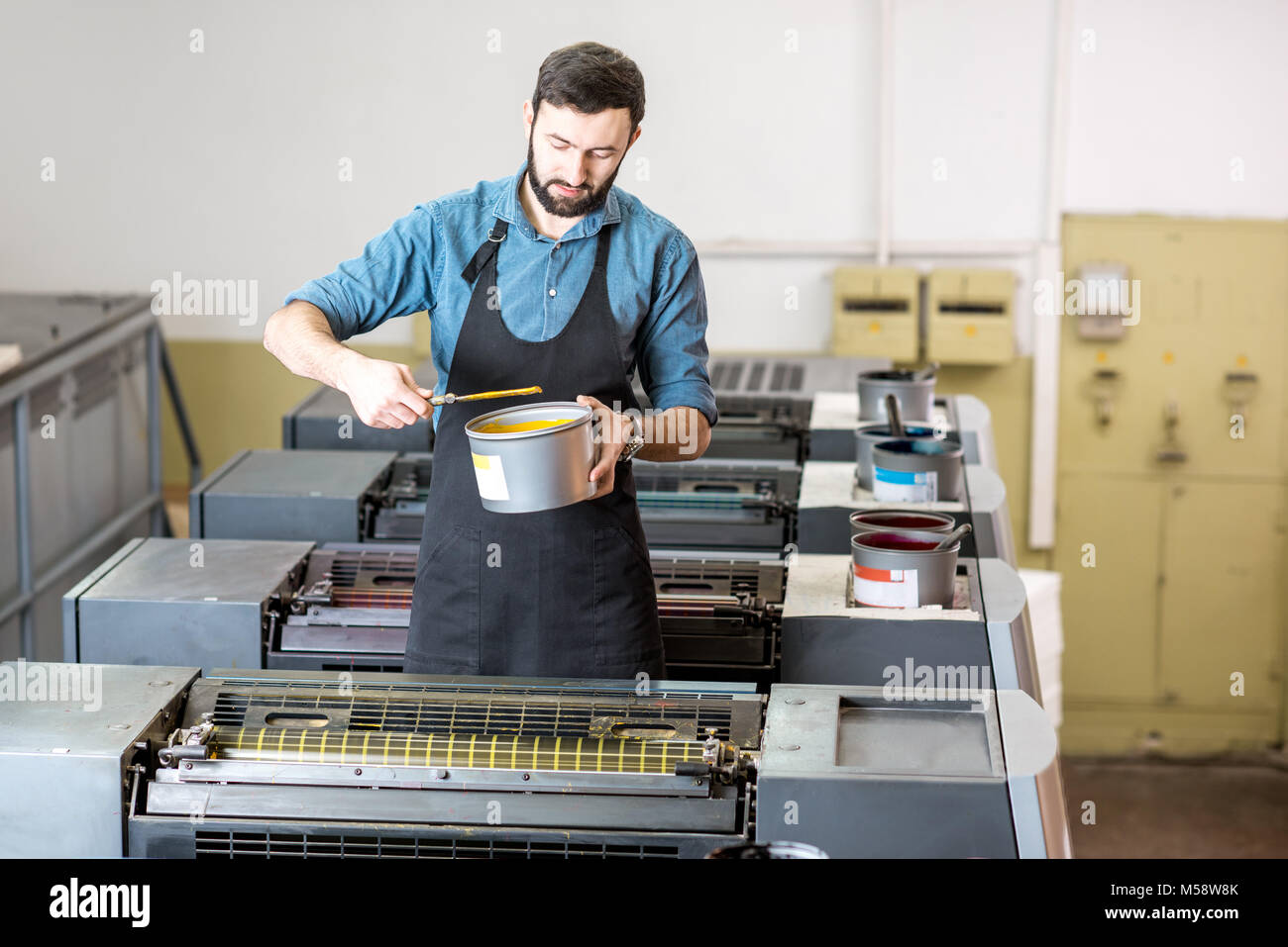 Typographer with paint at the manufacturing Stock Photo - Alamy