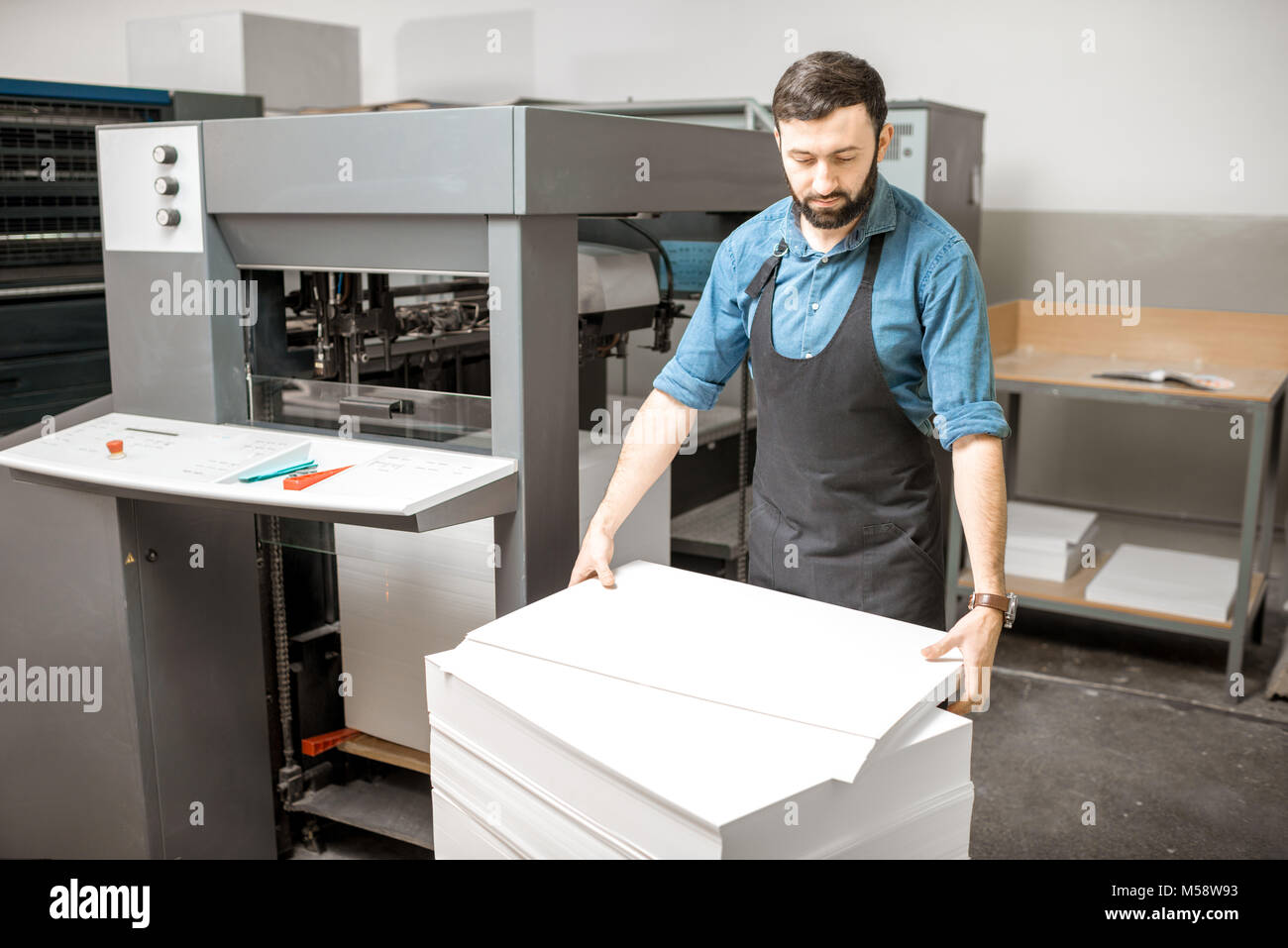 Feeling a paper into the printing machine Stock Photo - Alamy
