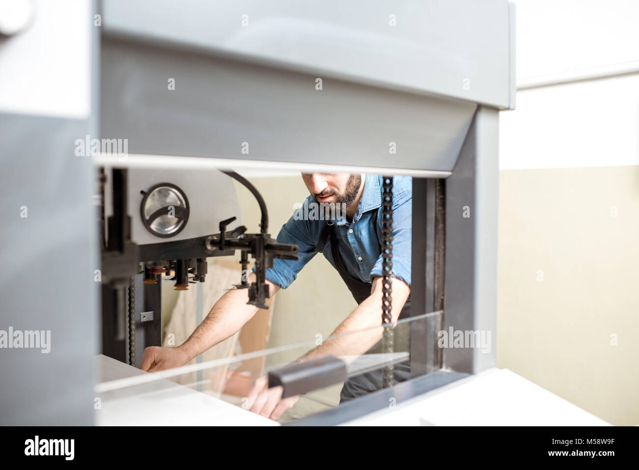 Feeling a paper into the printing machine Stock Photo - Alamy