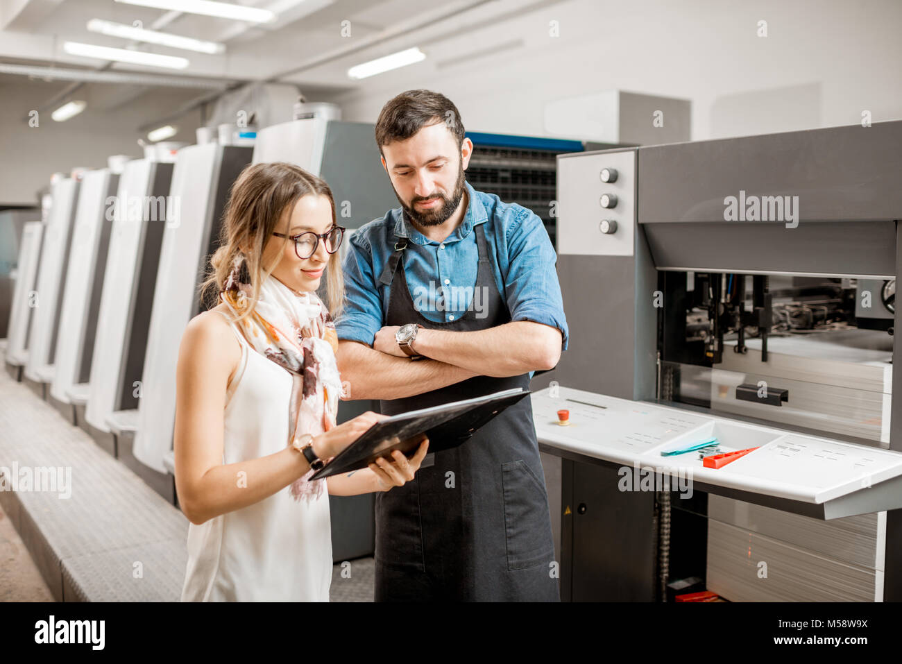 Woman with print operator at the printing manufacturing Stock Photo - Alamy