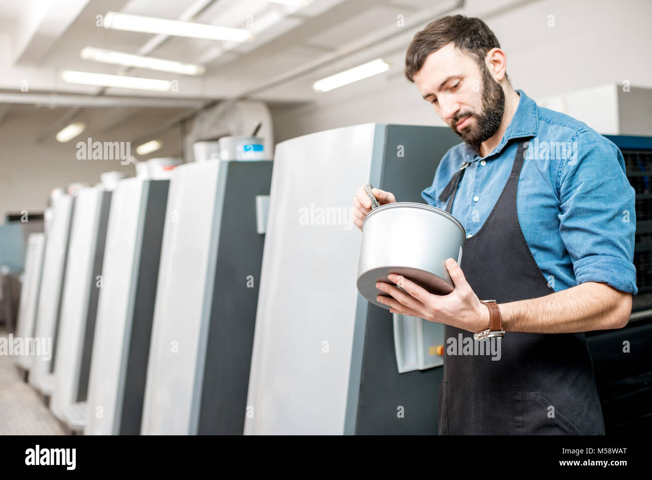 Typographer with paint at the manufacturing Stock Photo - Alamy