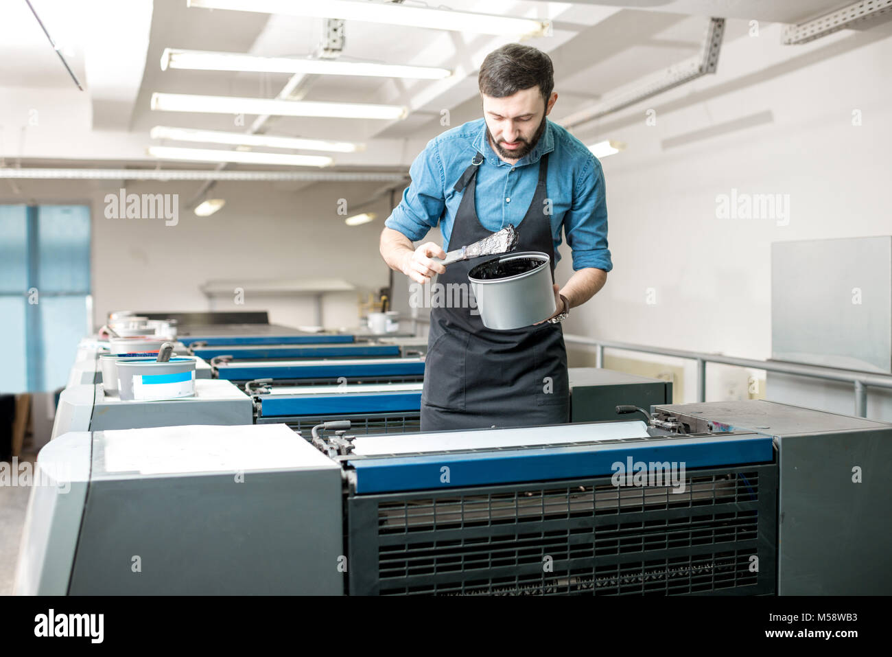 Typographer with paint at the manufacturing Stock Photo - Alamy