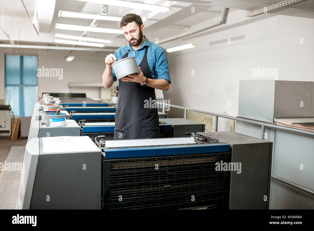 Typographer with paint at the manufacturing Stock Photo - Alamy
