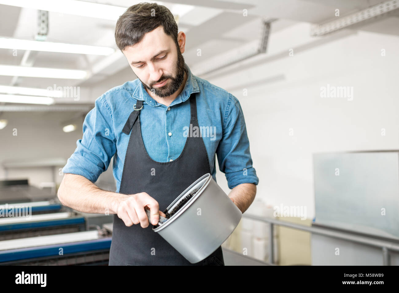 Typographer with paint at the manufacturing Stock Photo - Alamy