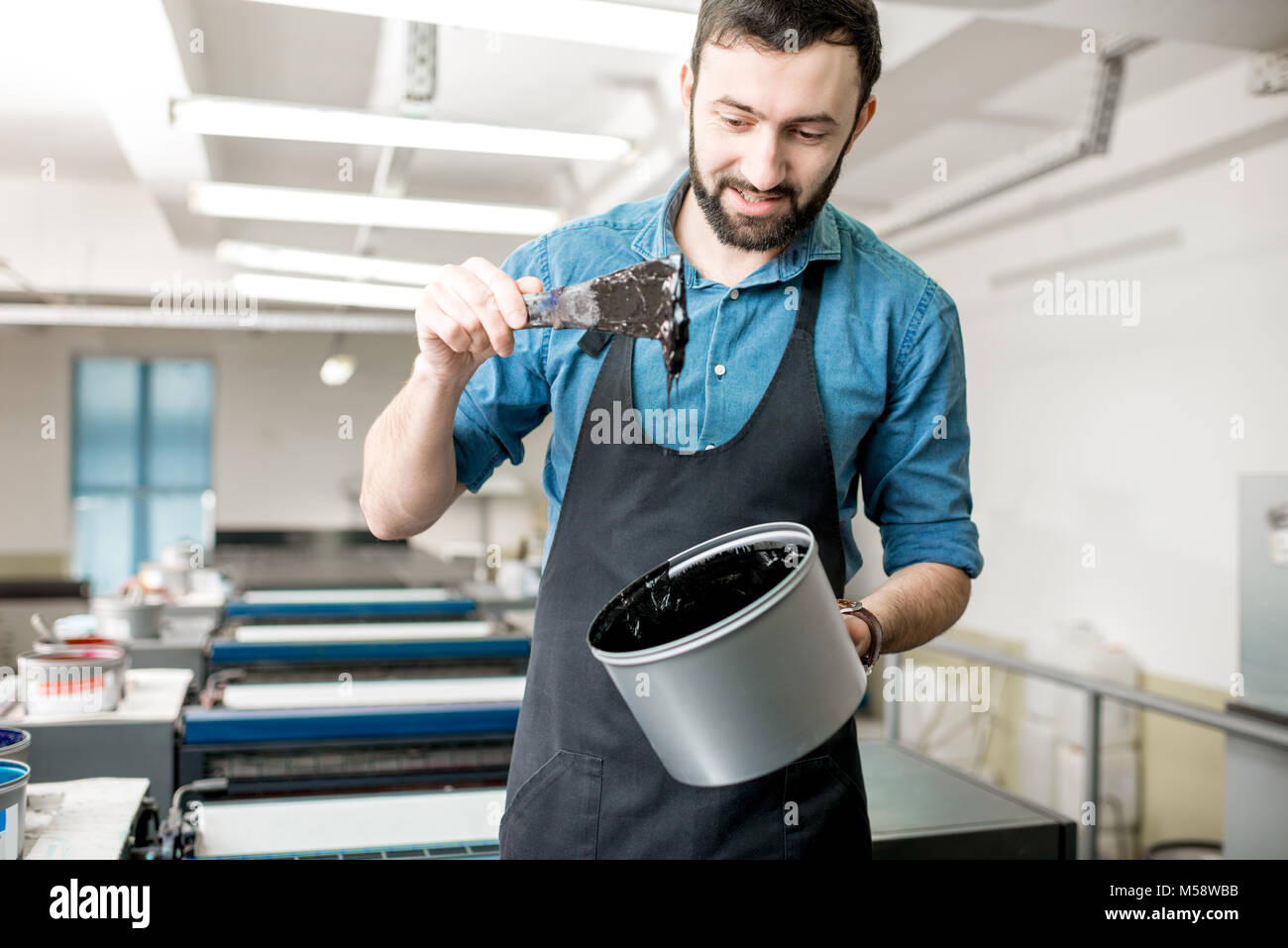 Typographer with paint at the manufacturing Stock Photo - Alamy