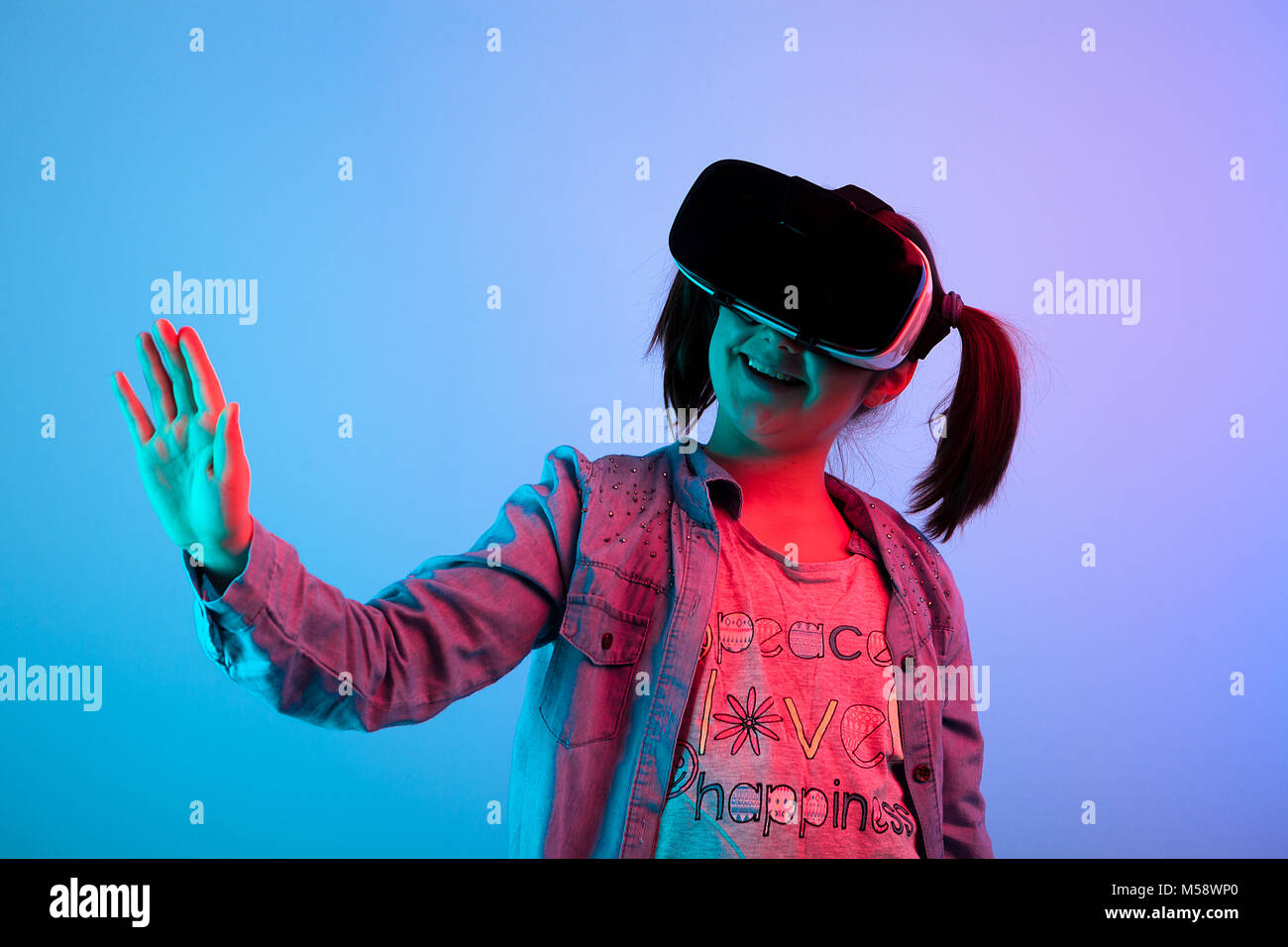 Happy young girl touching a virtual button Stock Photo - Alamy