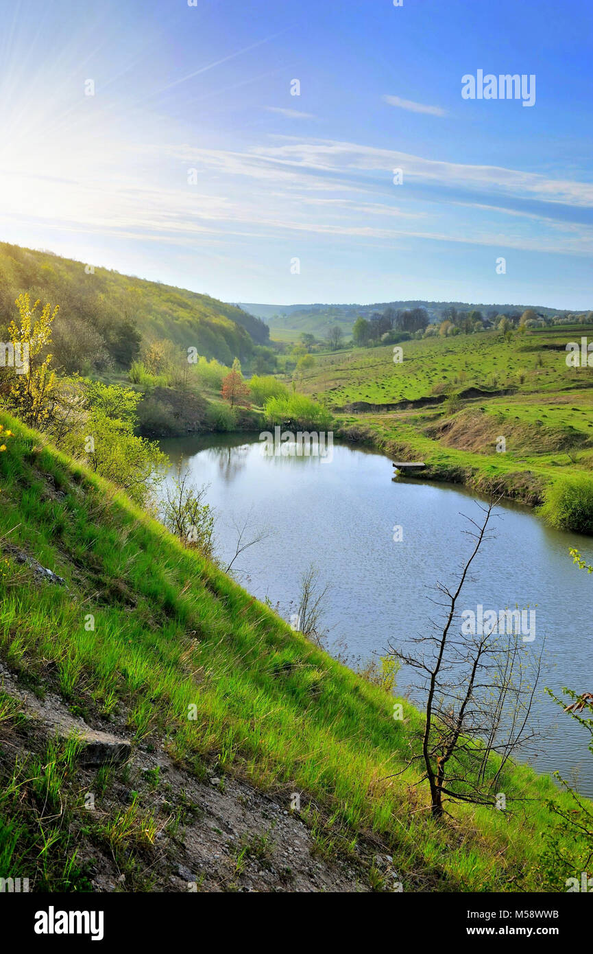 Spring sunny landscape with a lake. View from the hill Stock Photo - Alamy