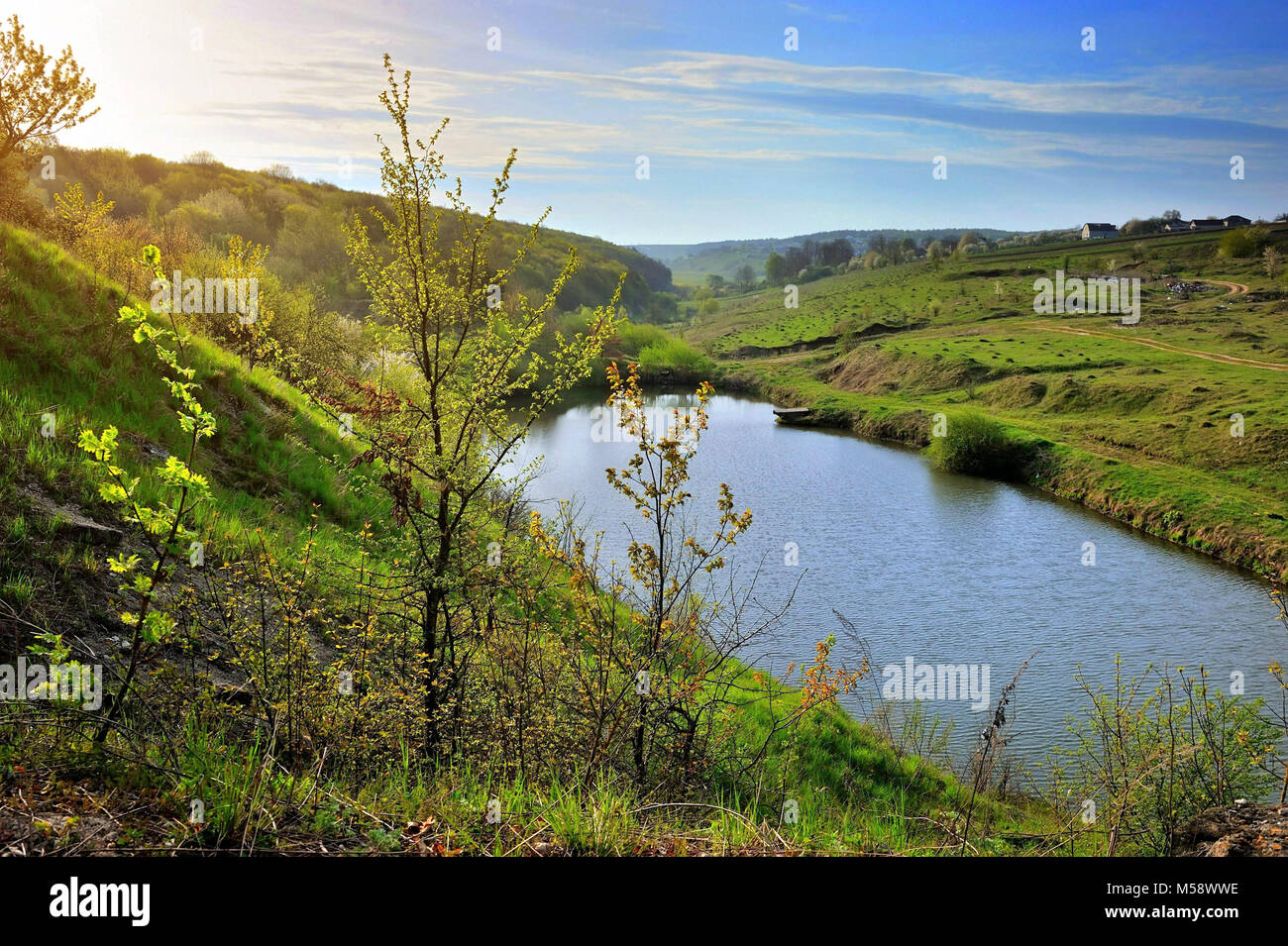 Spring sunny landscape with a lake. View from the hill Stock Photo - Alamy