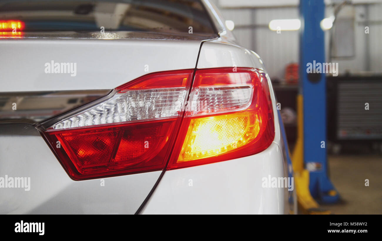 Auto service - checking back headlights of car Stock Photo - Alamy